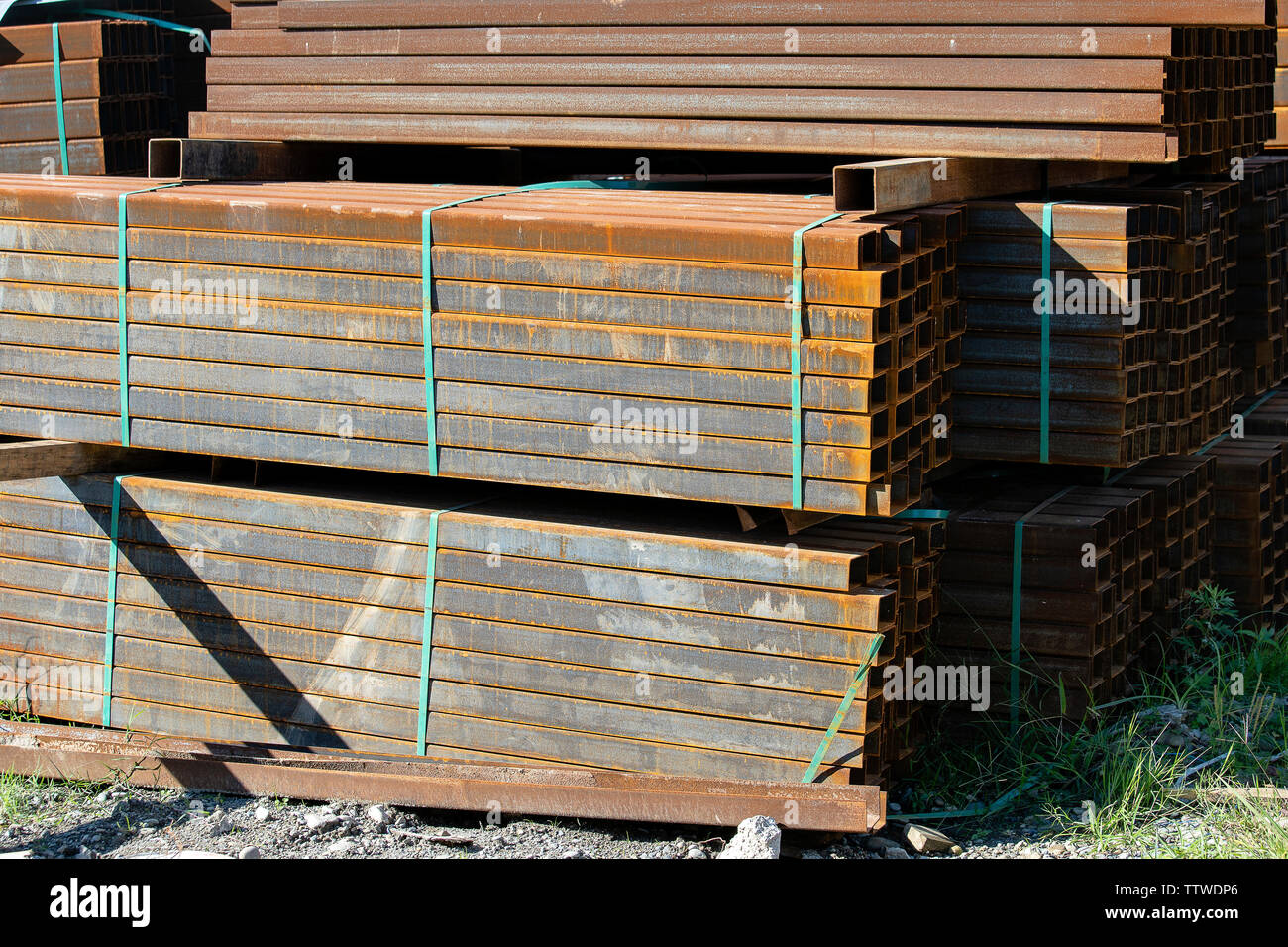 Rusty rectangular metal pipe in the packs are stored in the metal ...