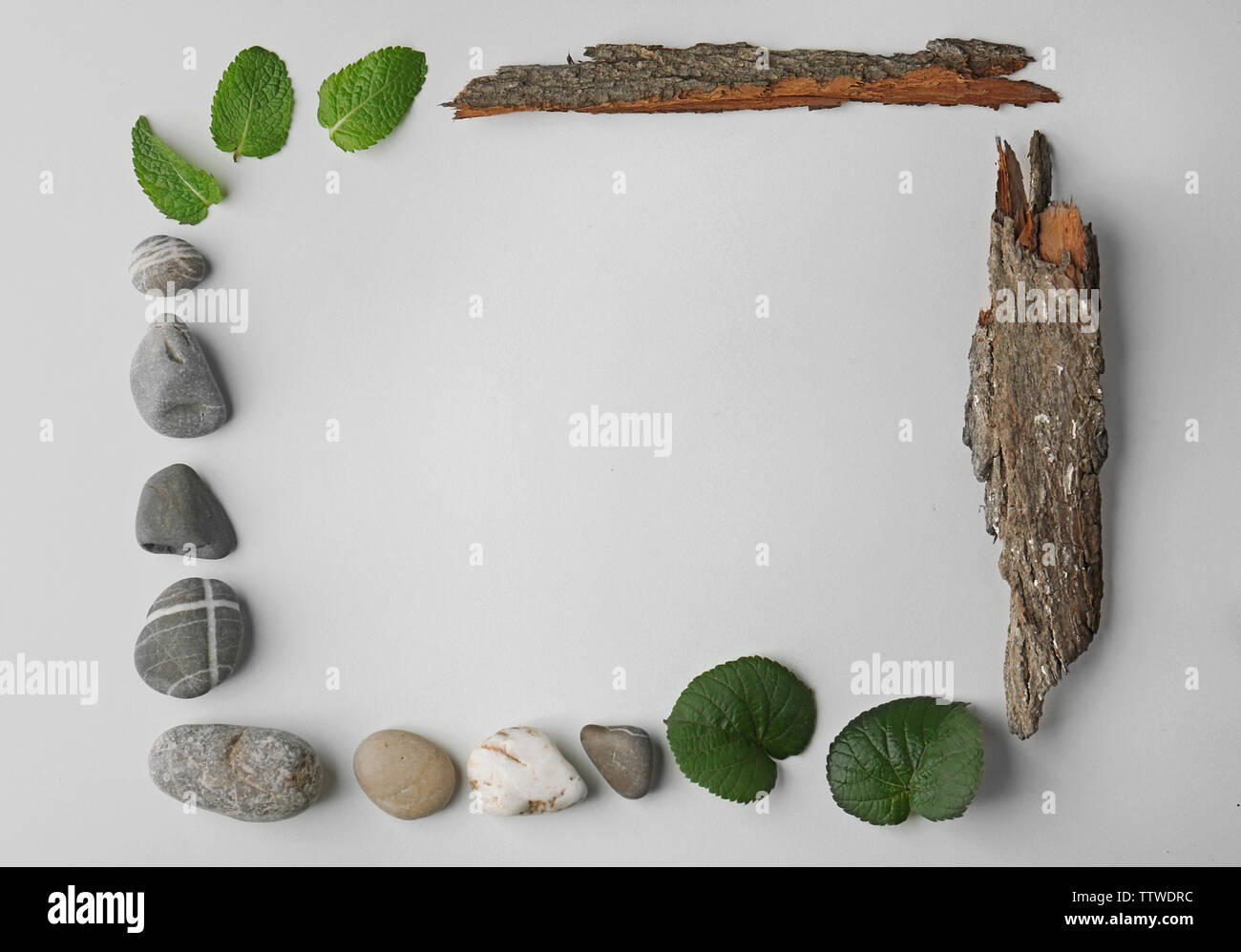 Rectangular frame made of pebbles, leaves and bark isolated on white ...