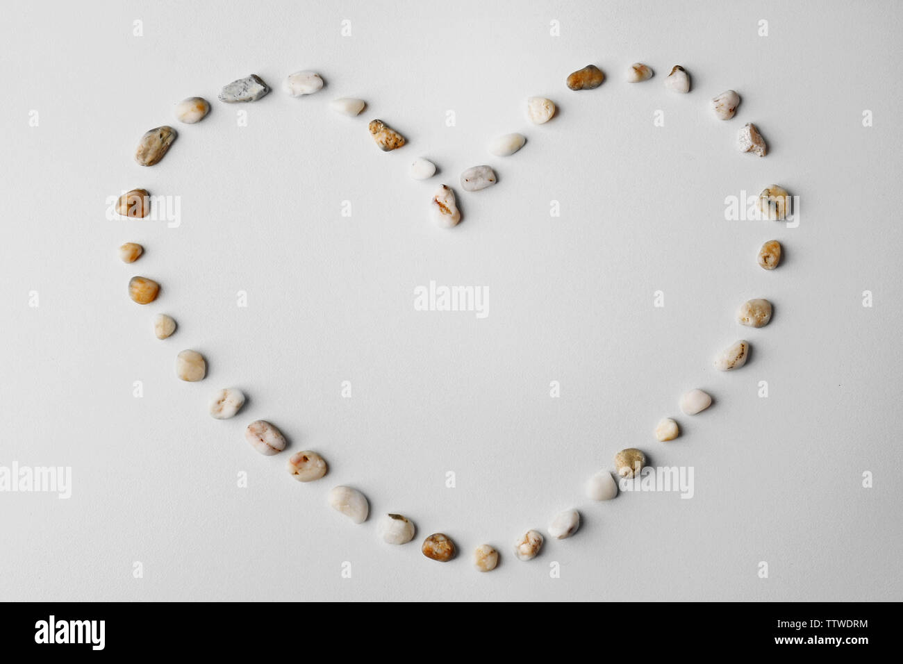 Heart made of small pebbles, isolated on white Stock Photo - Alamy