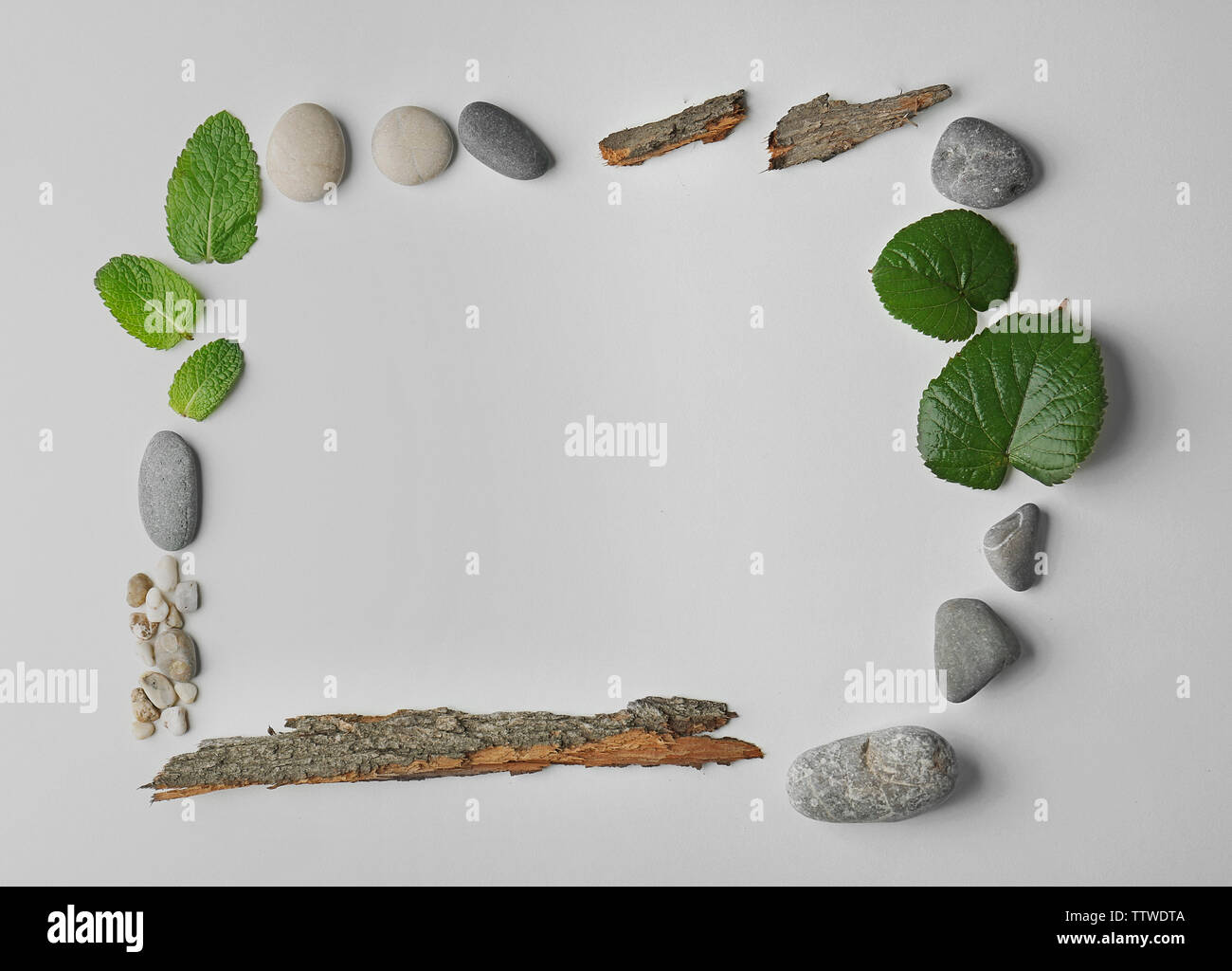 Rectangular frame made of pebbles, leaves and bark isolated on white ...
