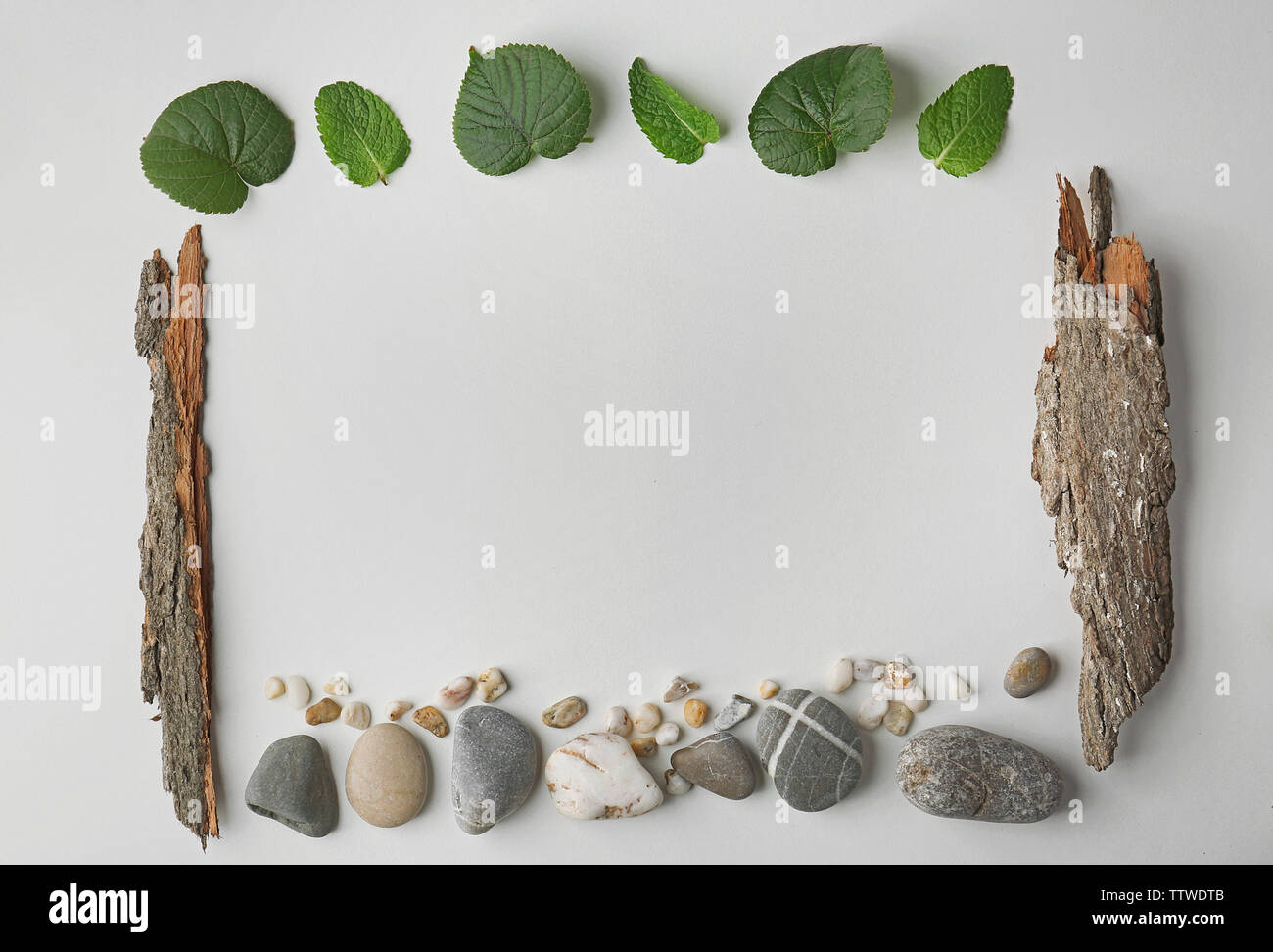 Rectangular frame made of pebbles, leaves and bark isolated on white ...