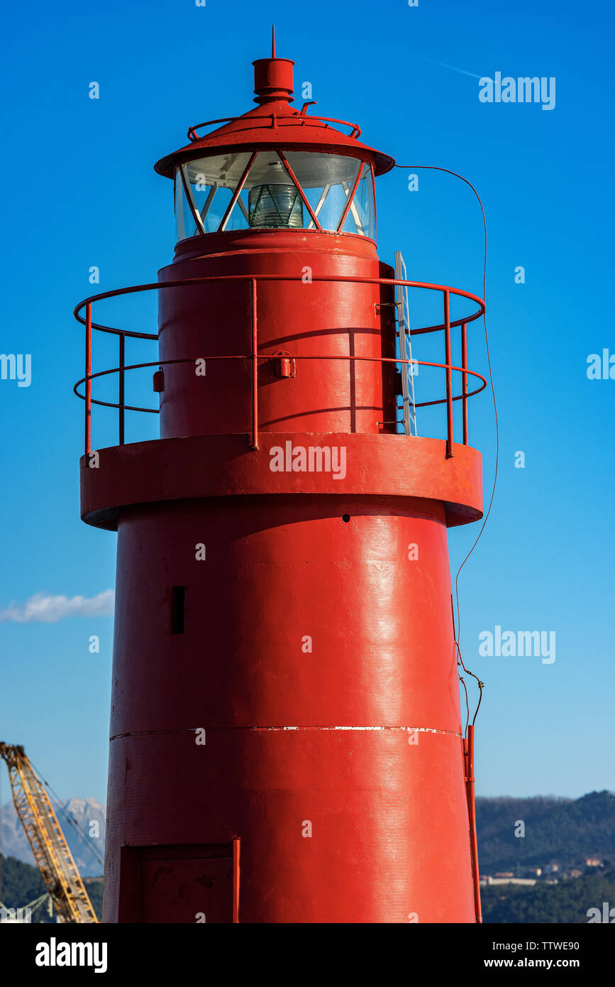 Close-up of a red lighthouse on a clear blue sky. Port of La Spezia ...