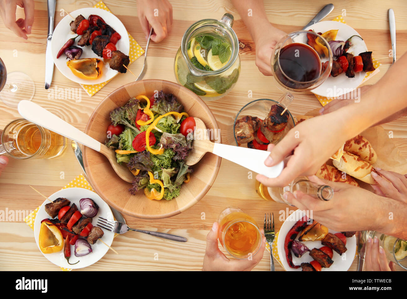 People having barbecue picnic at wooden table, top view Stock Photo - Alamy