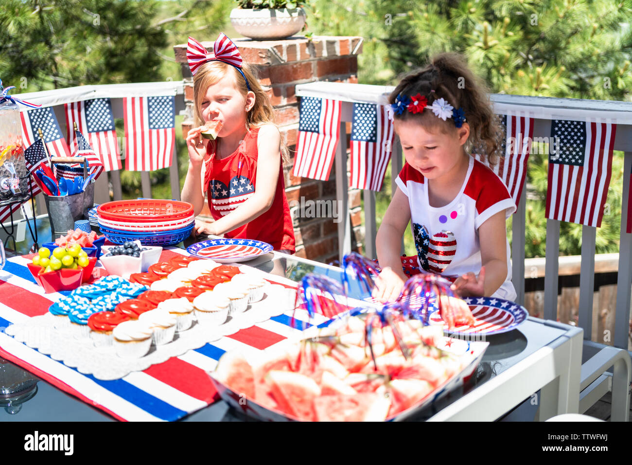 Little girls are playing at the July 4th party on the back patio Stock ...