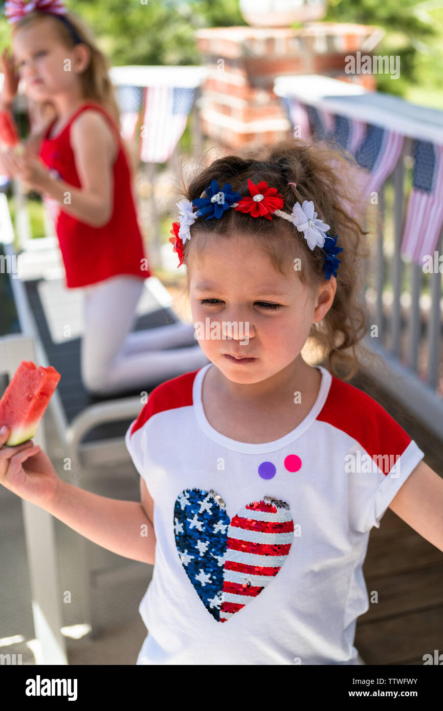 Little girls are playing at the July 4th party on the back patio Stock ...