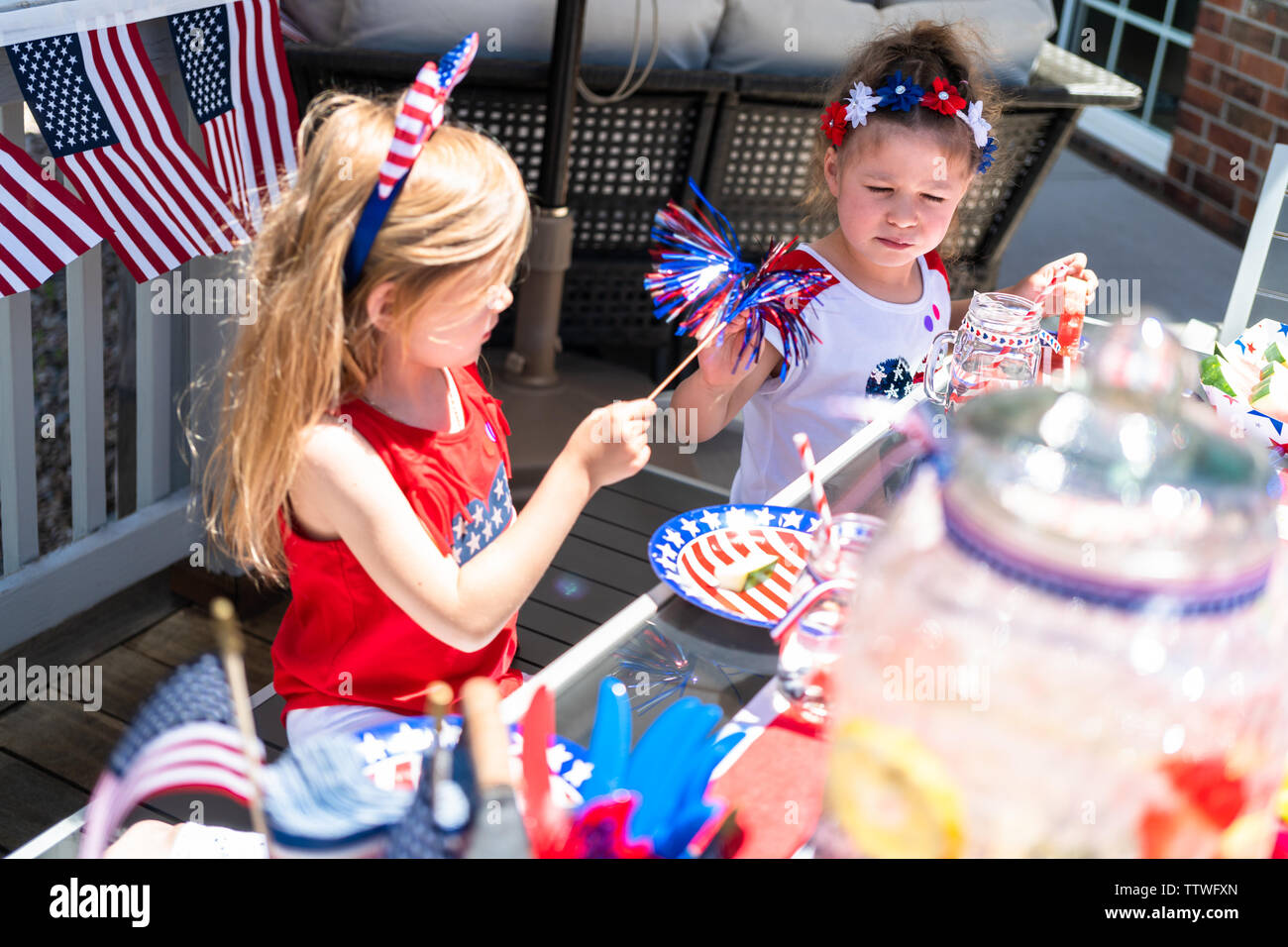 Little girls are playing at the July 4th party on the back patio Stock ...