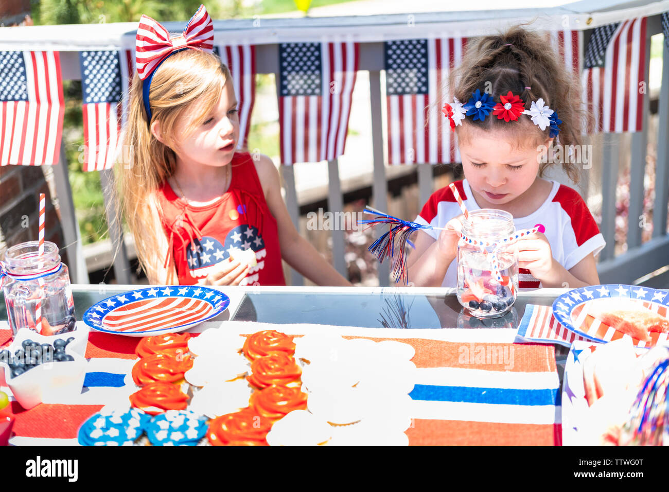 Little girls are playing at the July 4th party on the back patio Stock ...