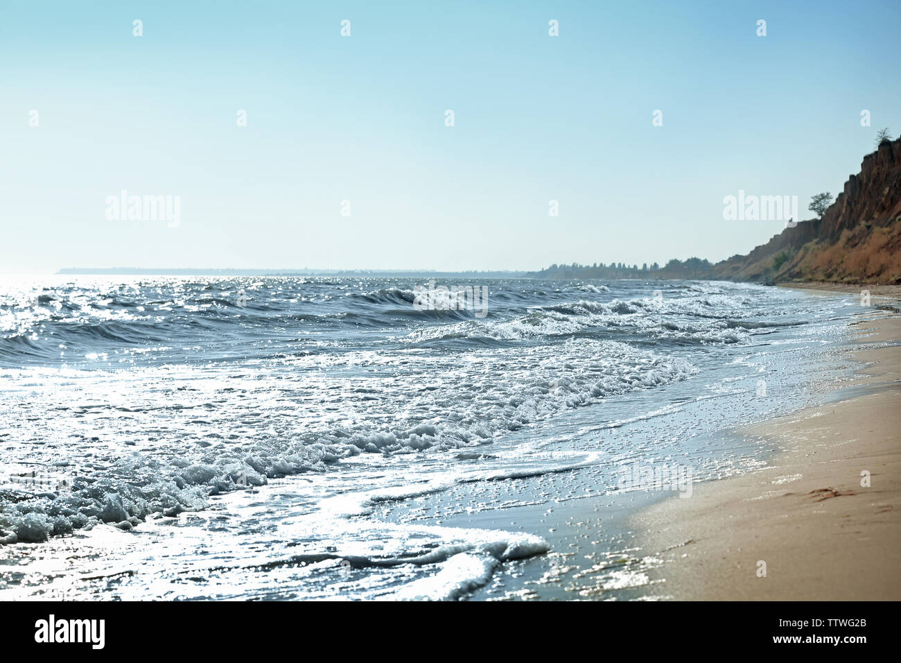 Beautiful beach and wavy sea Stock Photo - Alamy