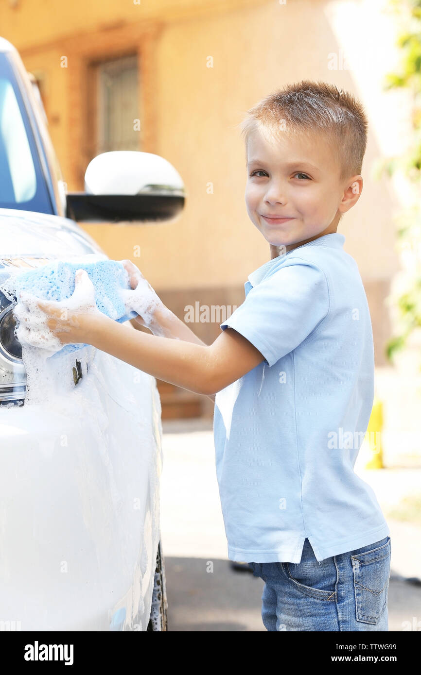 Small boy washing car with sponge on street Stock Photo - Alamy