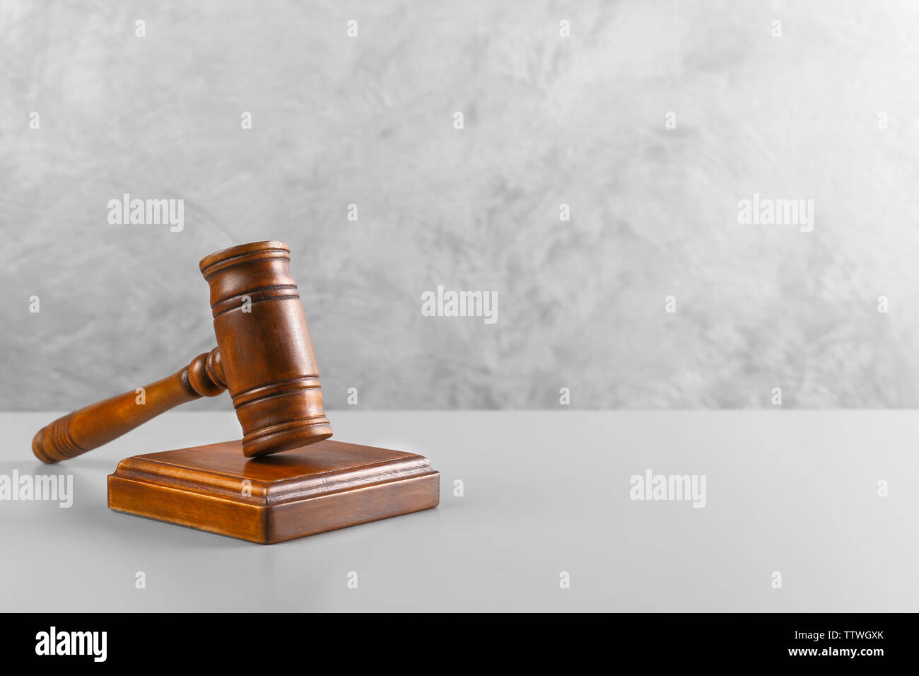 Judge's gavel and sound block on wall background Stock Photo - Alamy