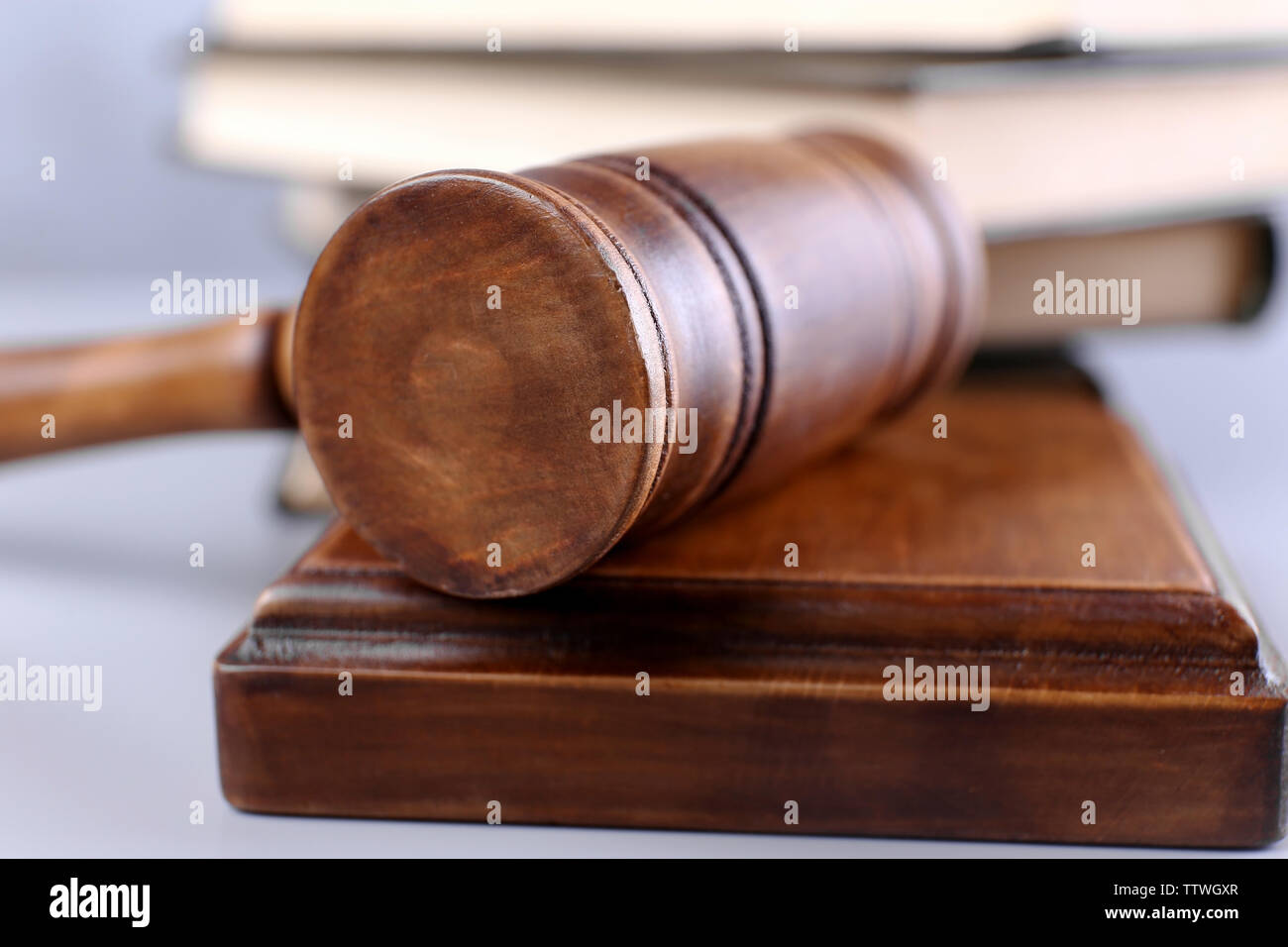 Judge's gavel with sound block and books on background Stock Photo - Alamy