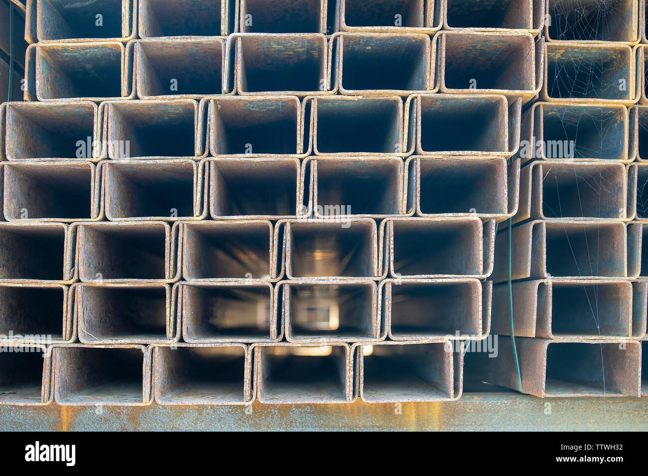 Rusty rectangular metal pipe in the packs are stored in the metal ...