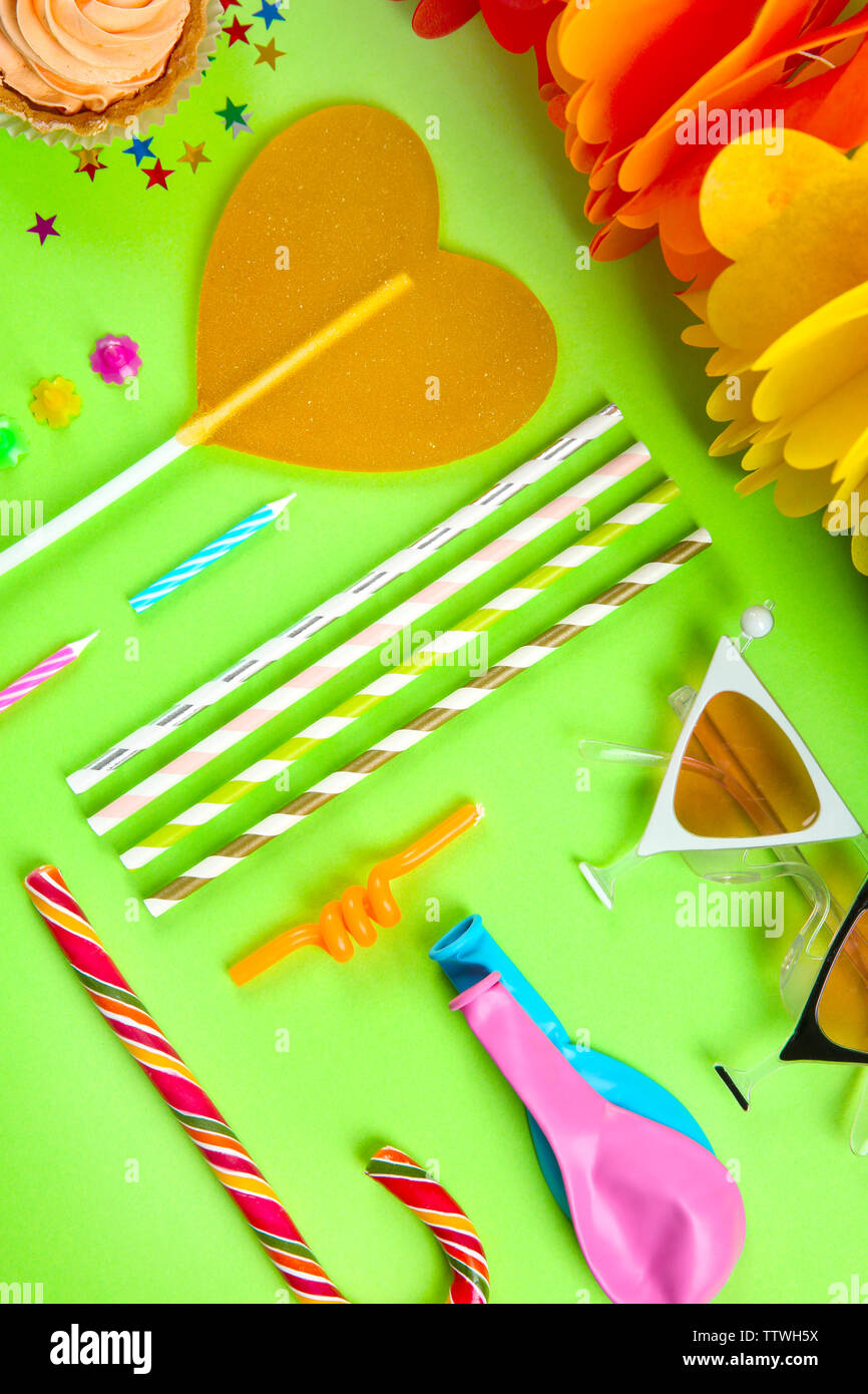 Flat lay. Festive objects on green background Stock Photo - Alamy