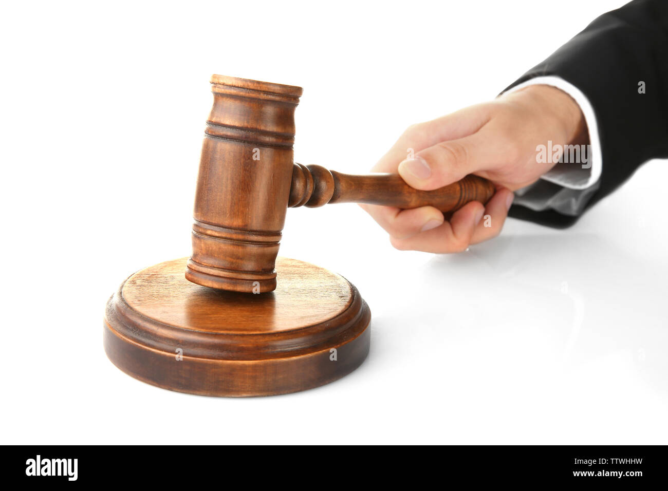 Judge's hand holding gavel on white background Stock Photo - Alamy