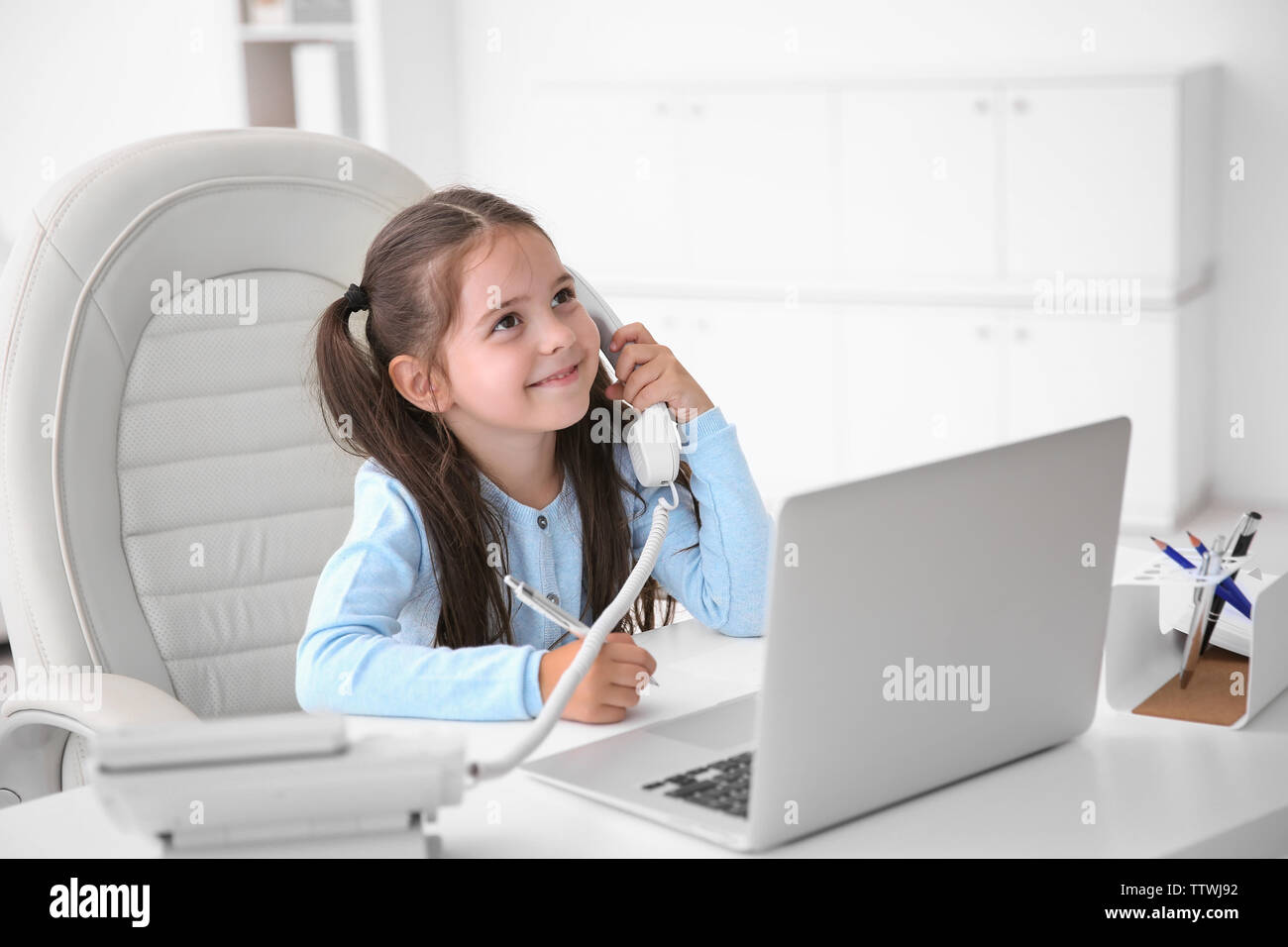 Small girl at father office Stock Photo - Alamy