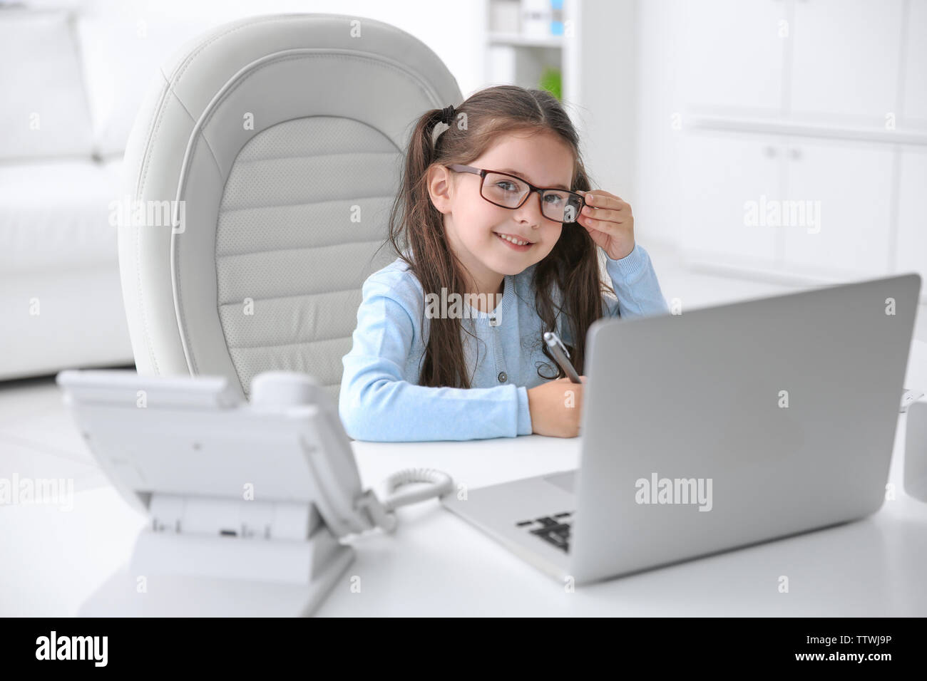 Small girl at father office Stock Photo - Alamy