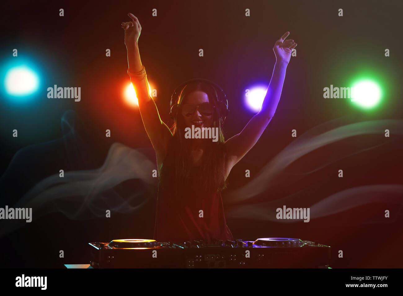 Pretty young DJ playing music in nightclub Stock Photo - Alamy