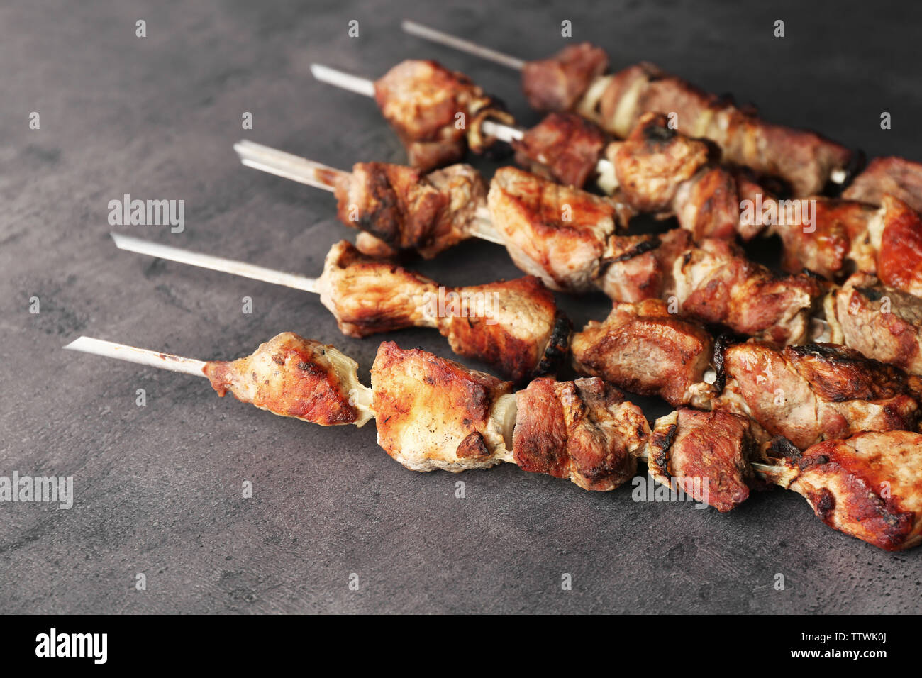 Fresh tasty barbecue on grey background Stock Photo - Alamy