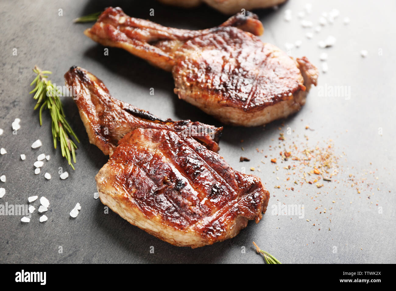Grilled meat on grey background Stock Photo - Alamy