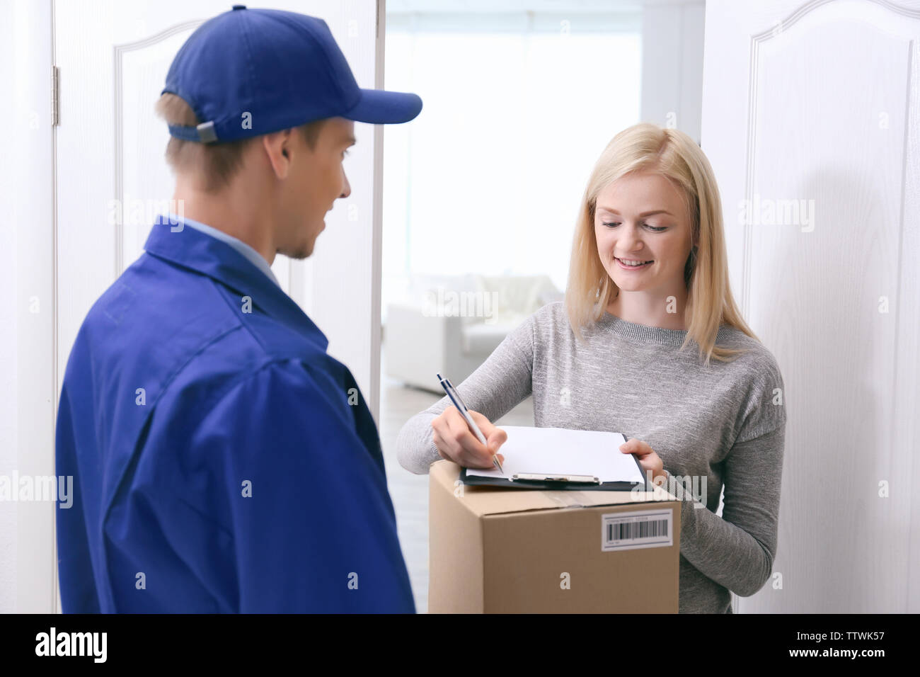 Signing for package hi-res stock photography and images - Alamy