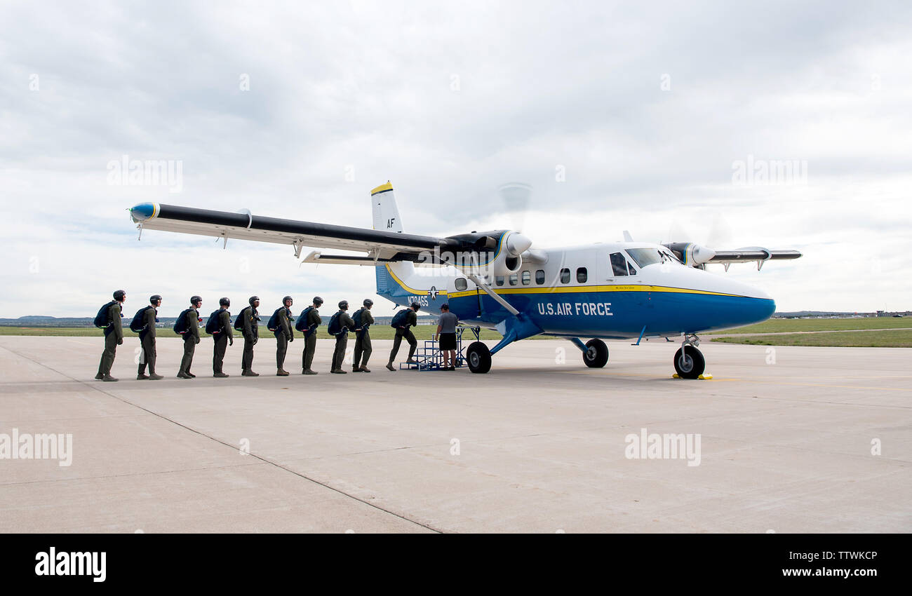 Cadets with parachutes, board a UV-18 B Twin Otter aircraft as part of ...
