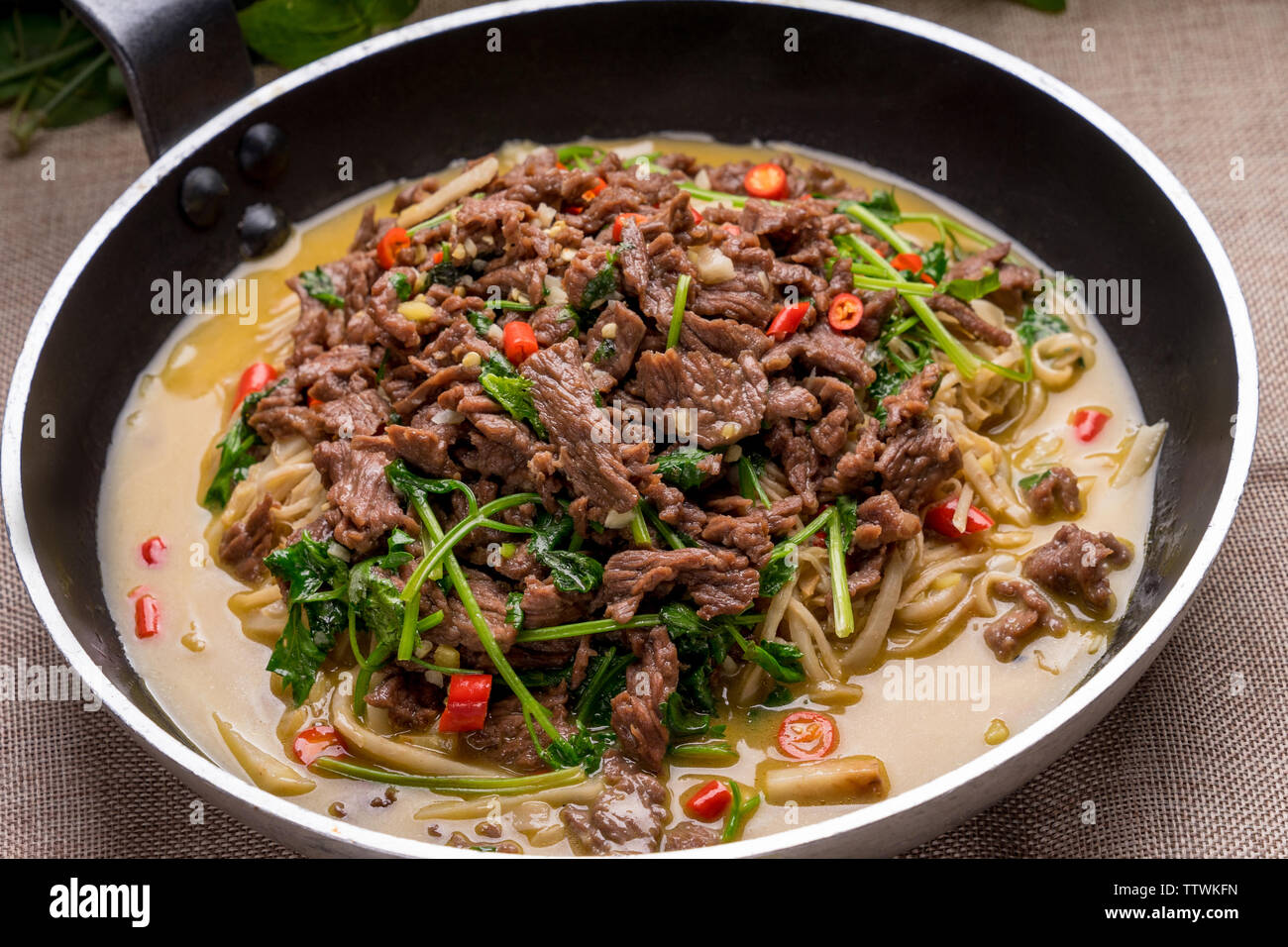 Celery golden needle mushroom stir-fried beef slices Stock Photo - Alamy