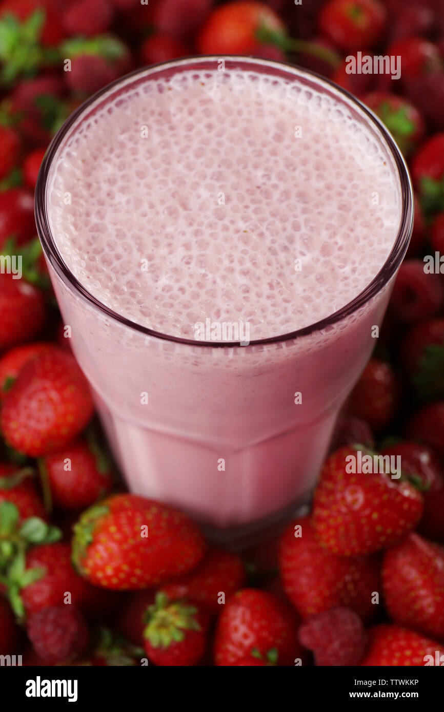 Strawberry milkshake on berry background Stock Photo - Alamy