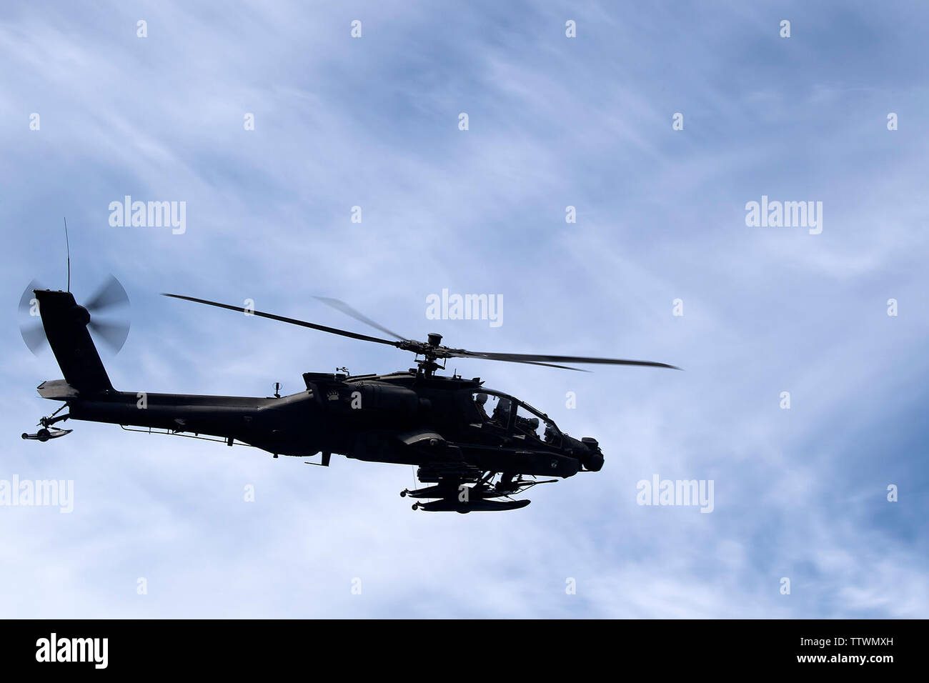 An AH-64 Apache flies overhead after completing close air support ...