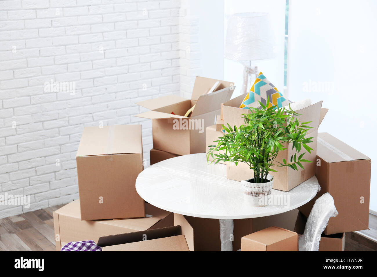 House moving concept. Boxes and furniture in the room Stock Photo - Alamy