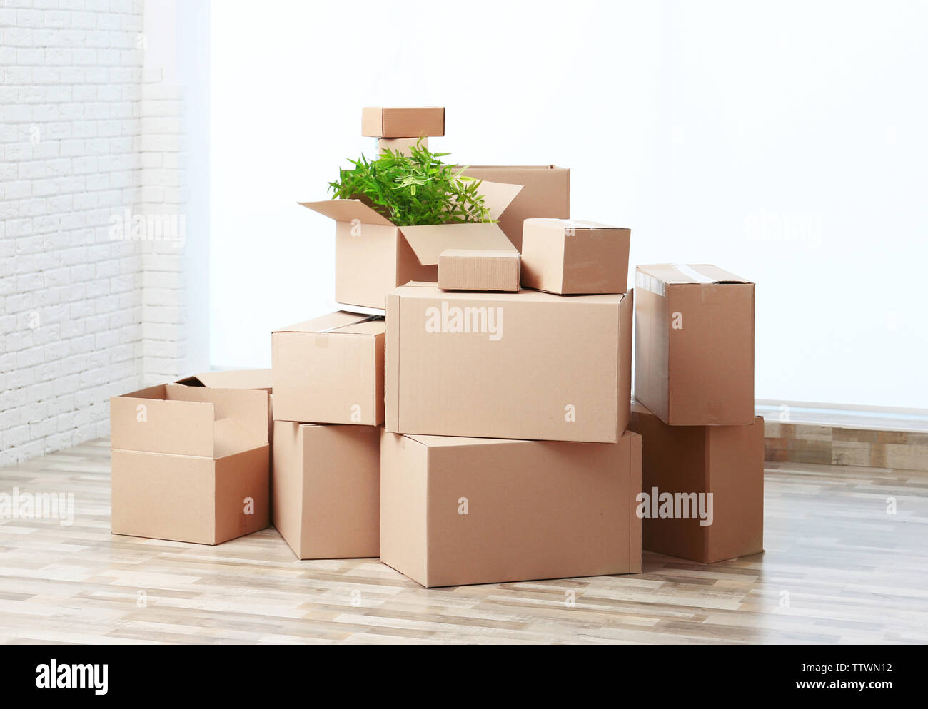House moving concept. Boxes in empty room Stock Photo - Alamy