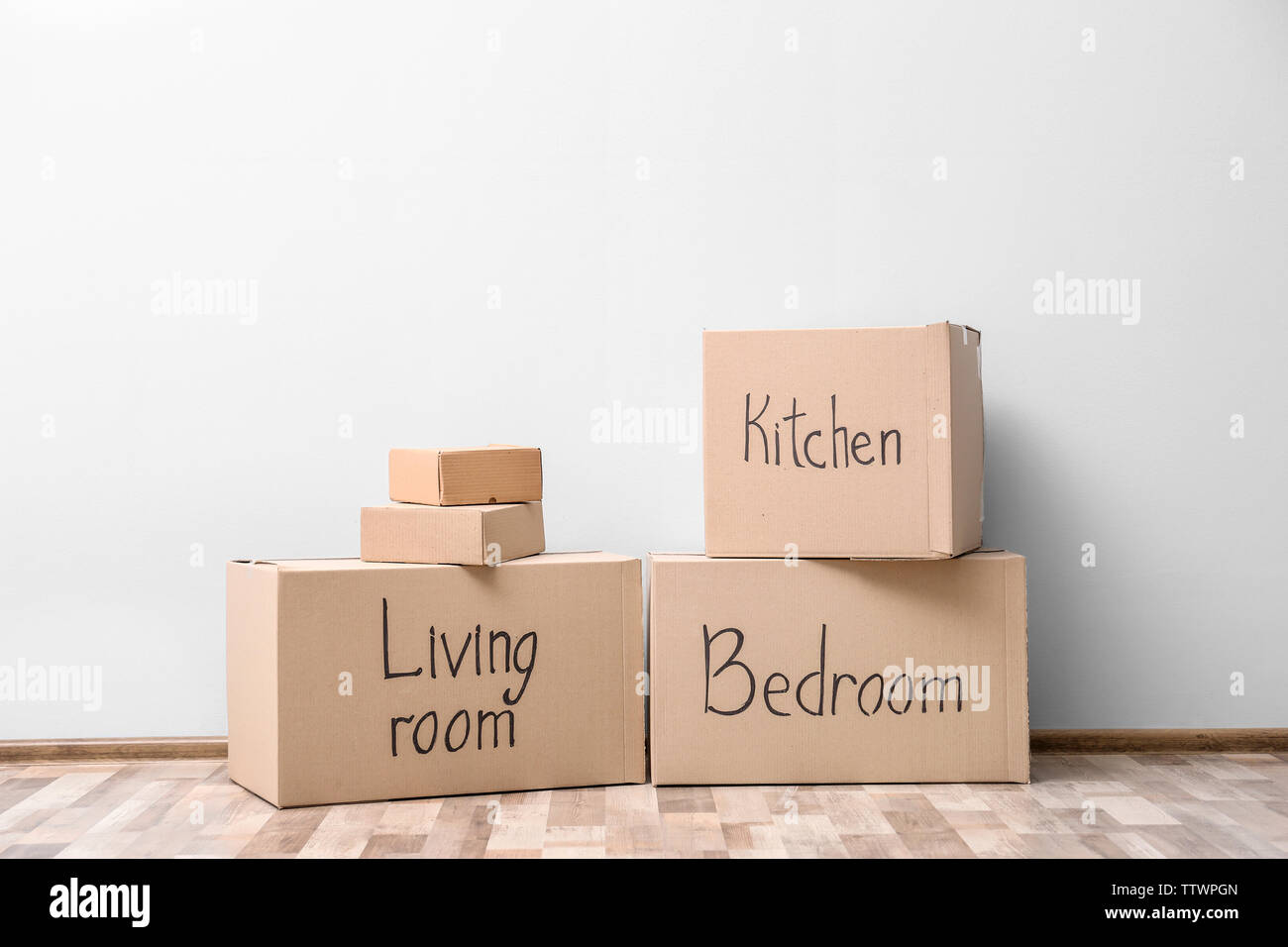 Empty room with moving boxes on wall background Stock Photo - Alamy