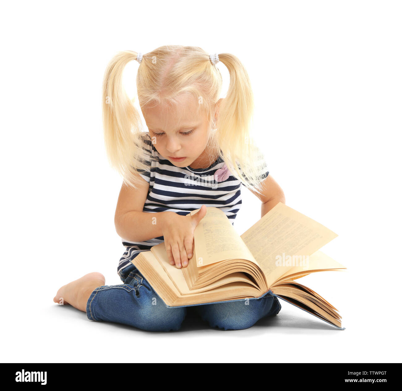 Cute small girl reading book on white background Stock Photo - Alamy