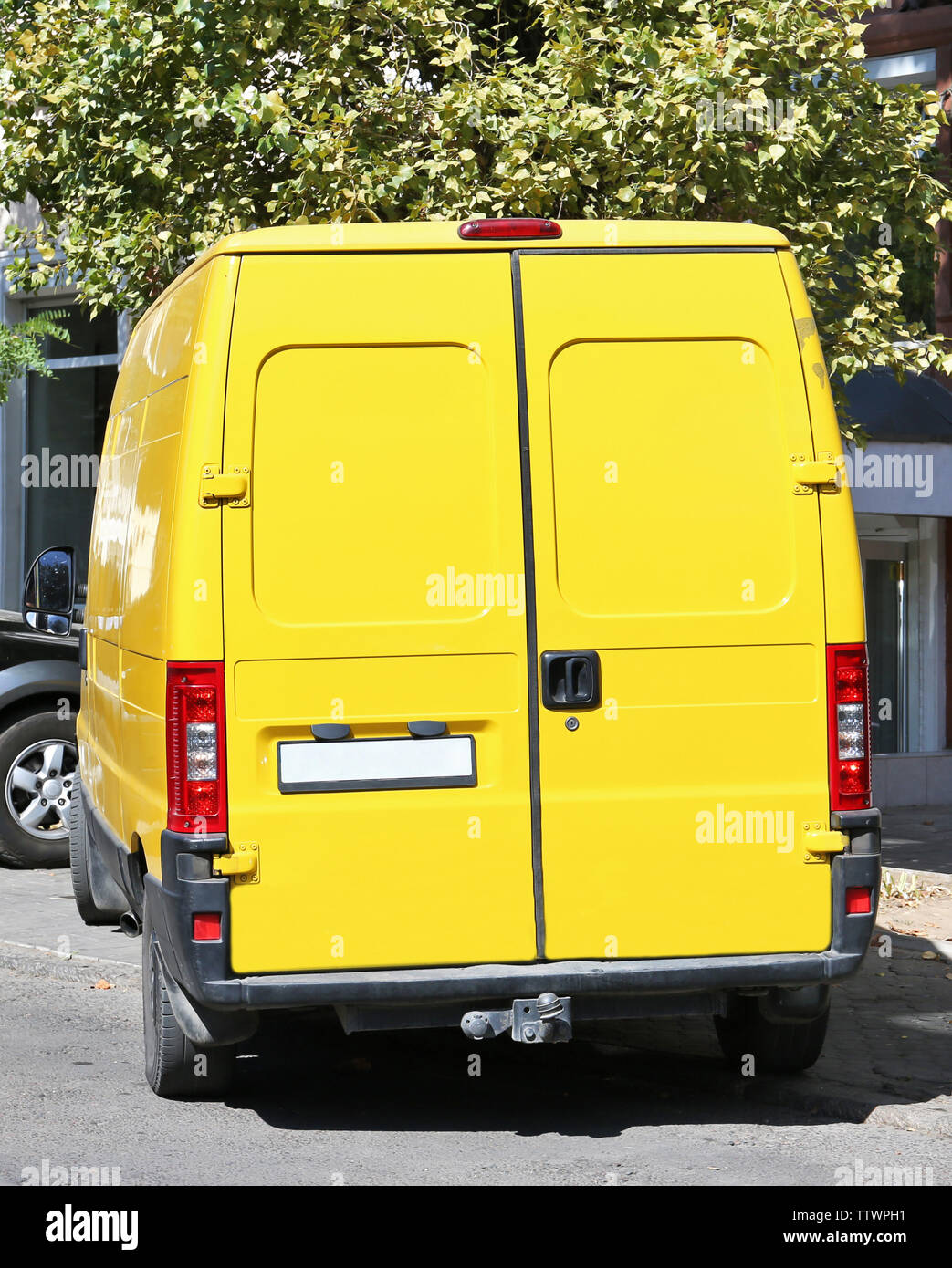 Yellow delivery car in the yard Stock Photo - Alamy