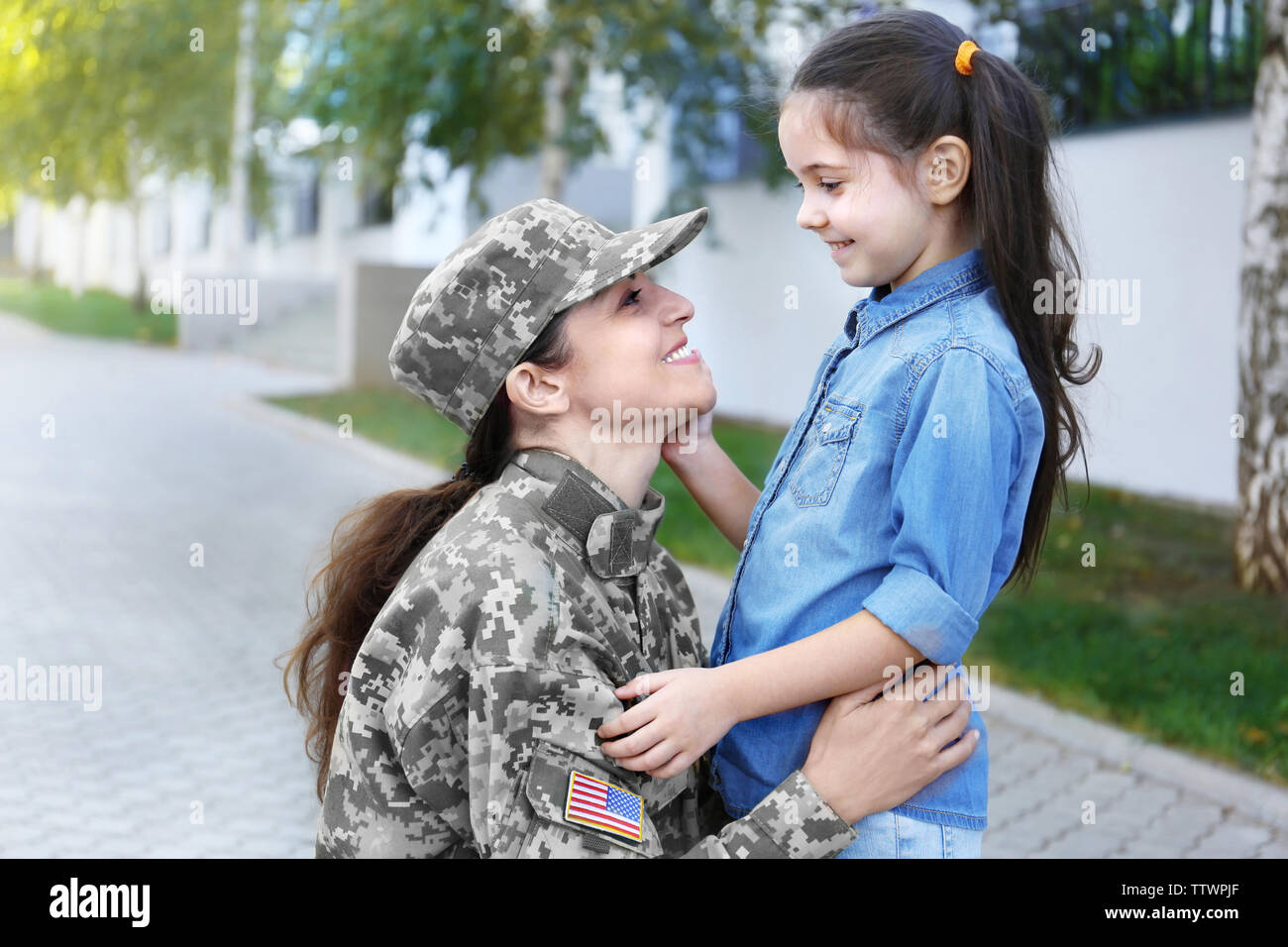 Mother in army uniform and daughter in the street Stock Photo - Alamy