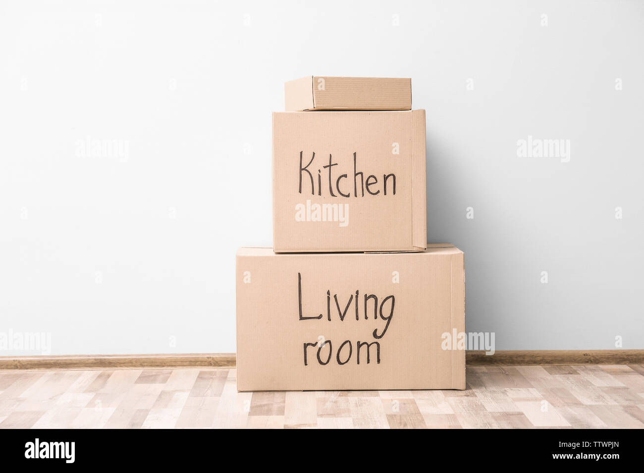 Empty room with moving boxes on wall background Stock Photo - Alamy