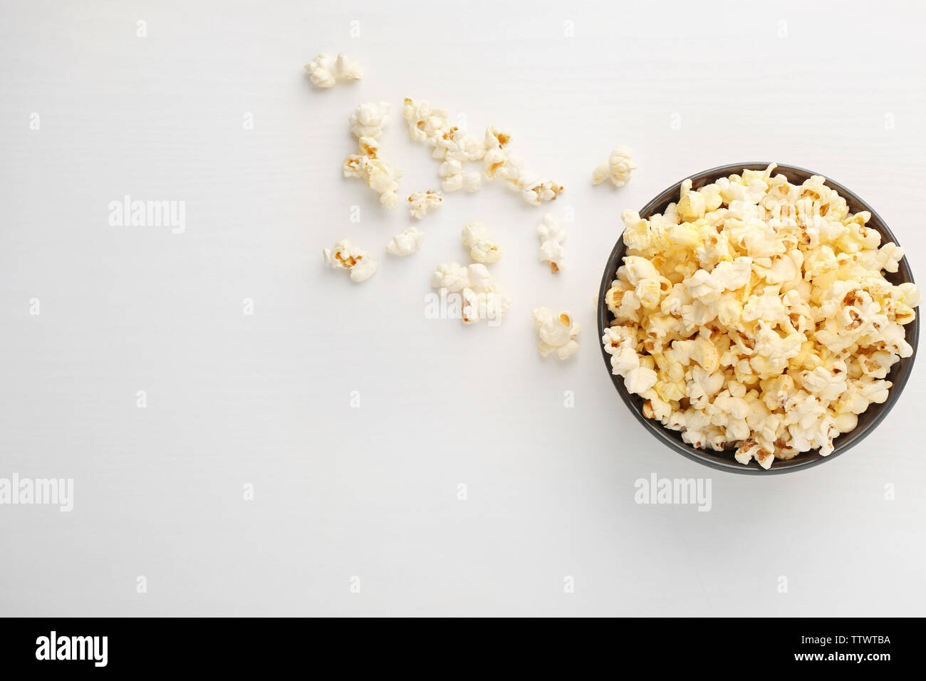 Popcorn in bowl on white background Stock Photo - Alamy
