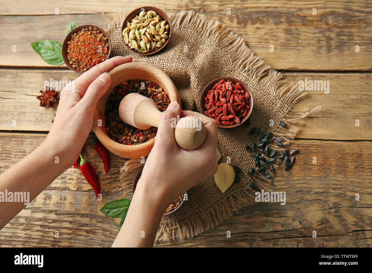 Woman grinding spices hi-res stock photography and images - Alamy