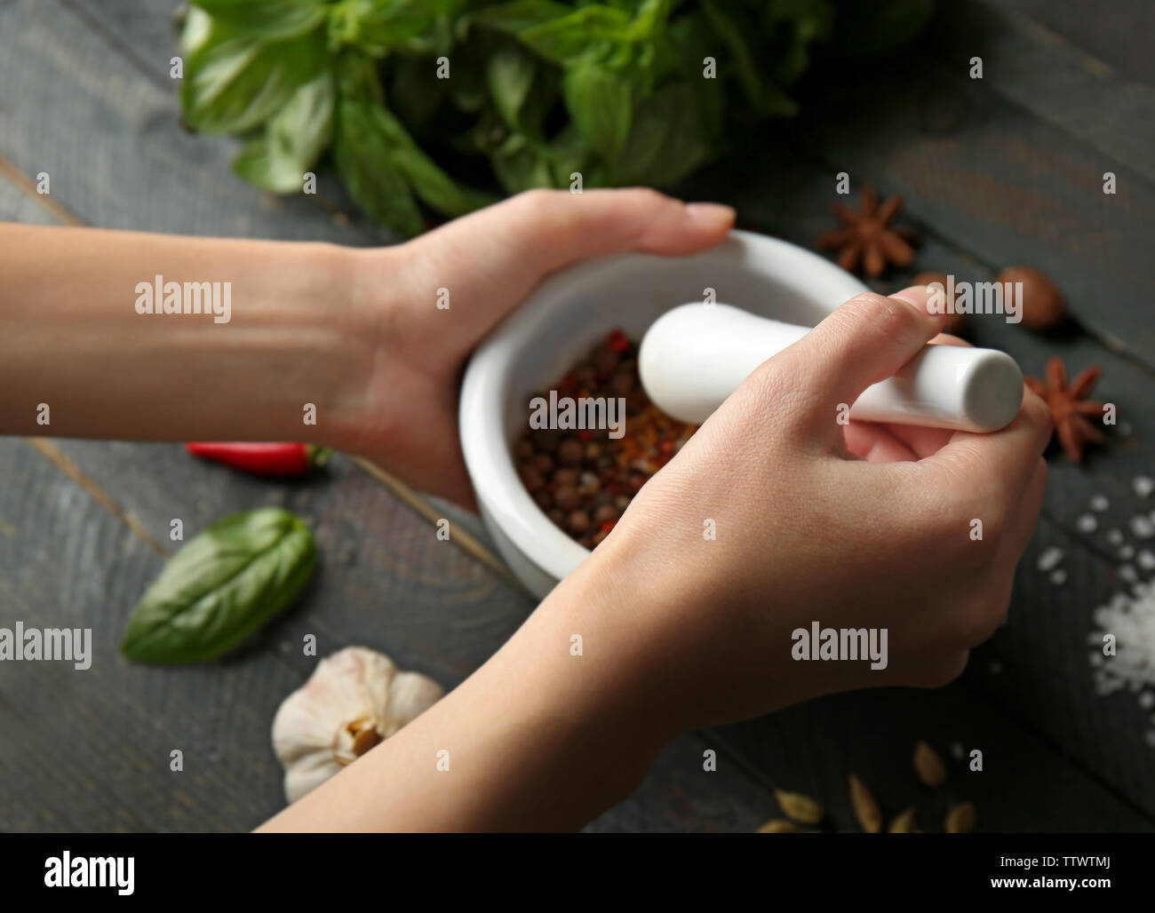 Female hands grinding spices in mortar Stock Photo - Alamy