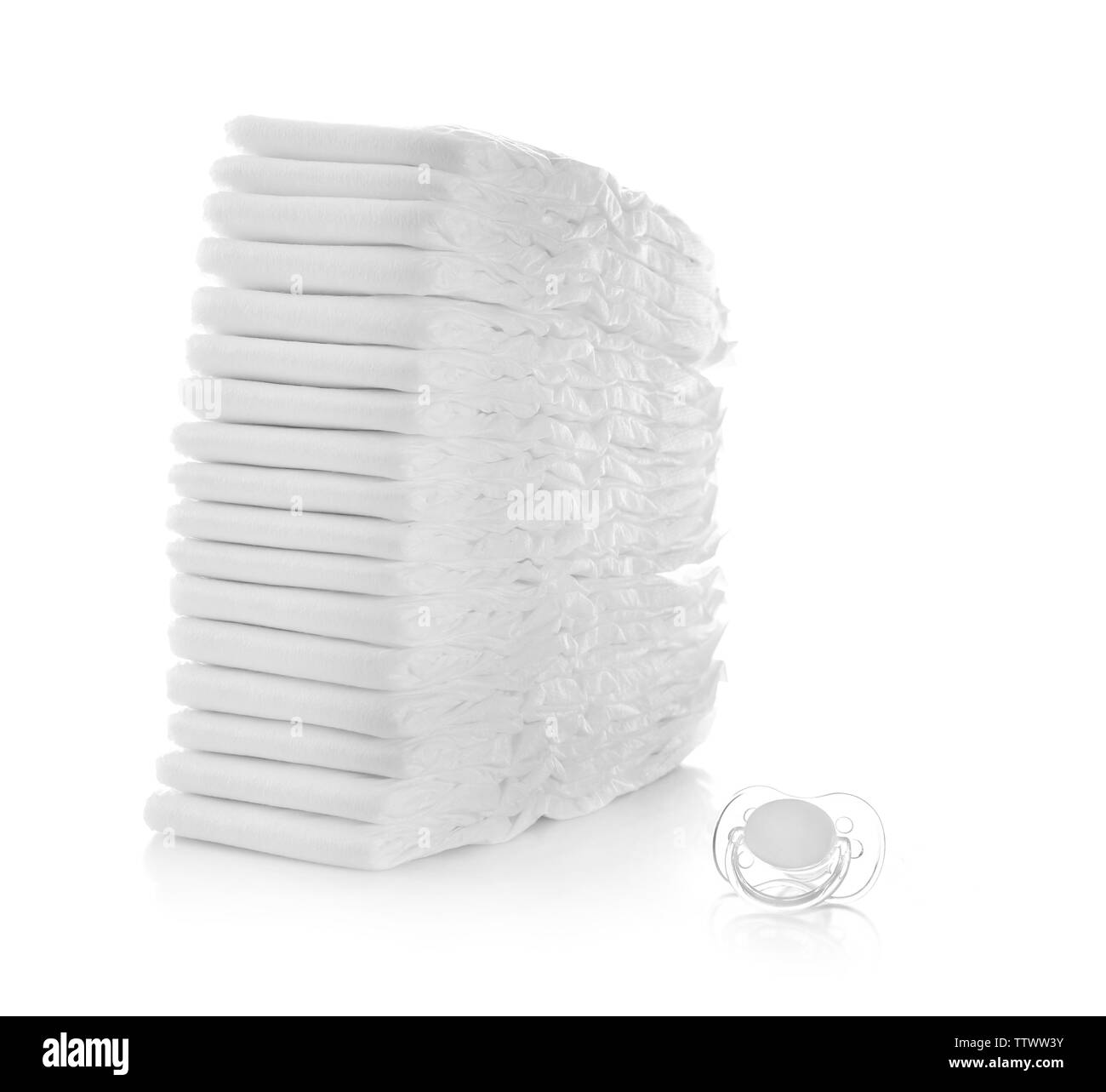Stack of baby's diapers and dummy isolated on white Stock Photo - Alamy