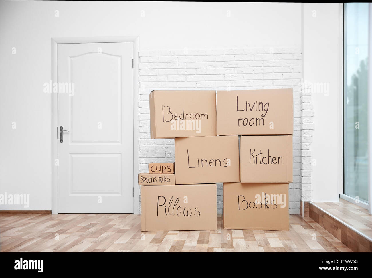 Moving boxes in room on light background Stock Photo - Alamy