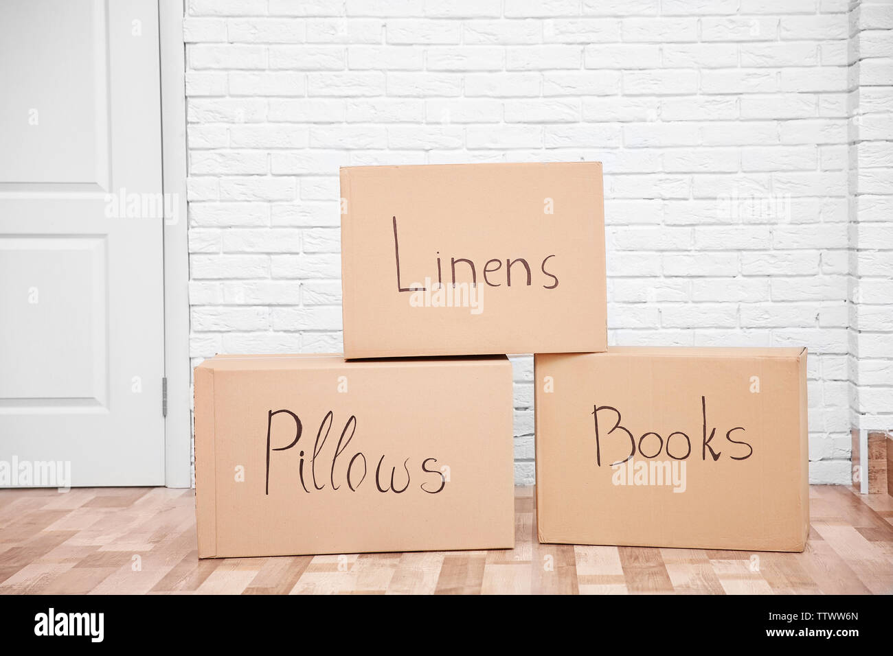 Moving boxes in room on light background Stock Photo - Alamy