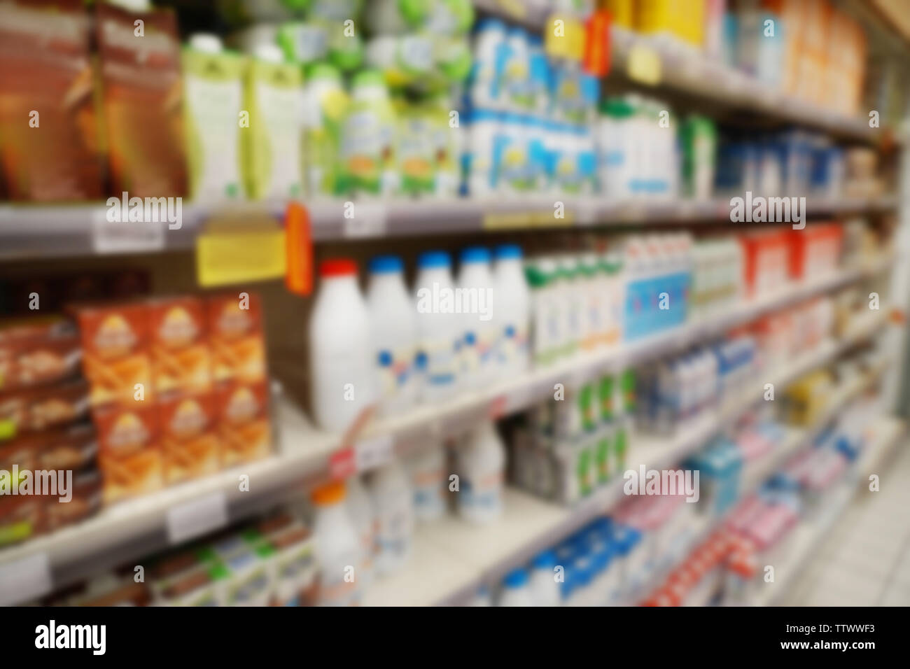 Blurred view of shelves with food stuff in supermarket Stock Photo - Alamy