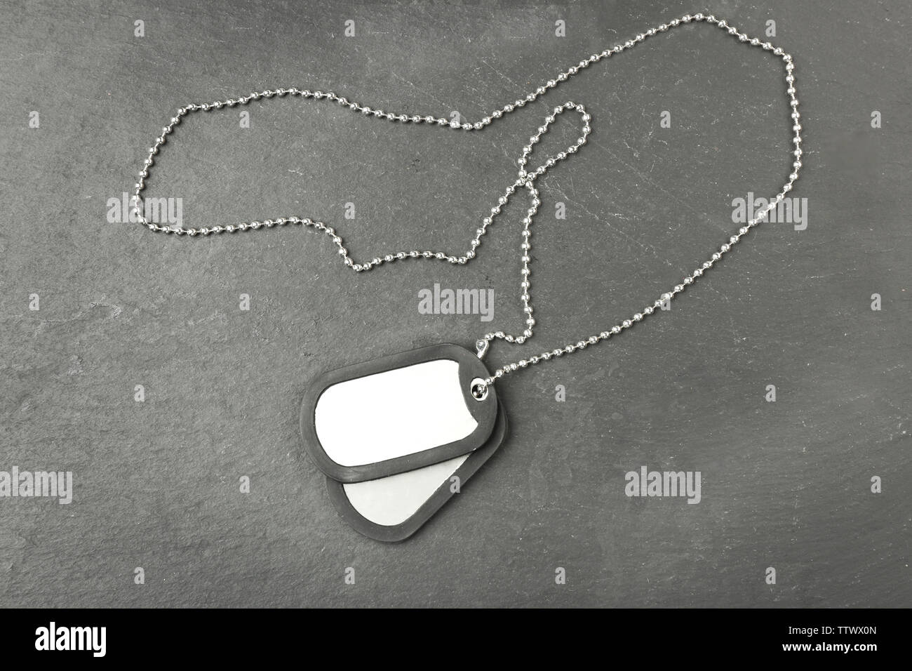 Military ID tags on dark background Stock Photo - Alamy