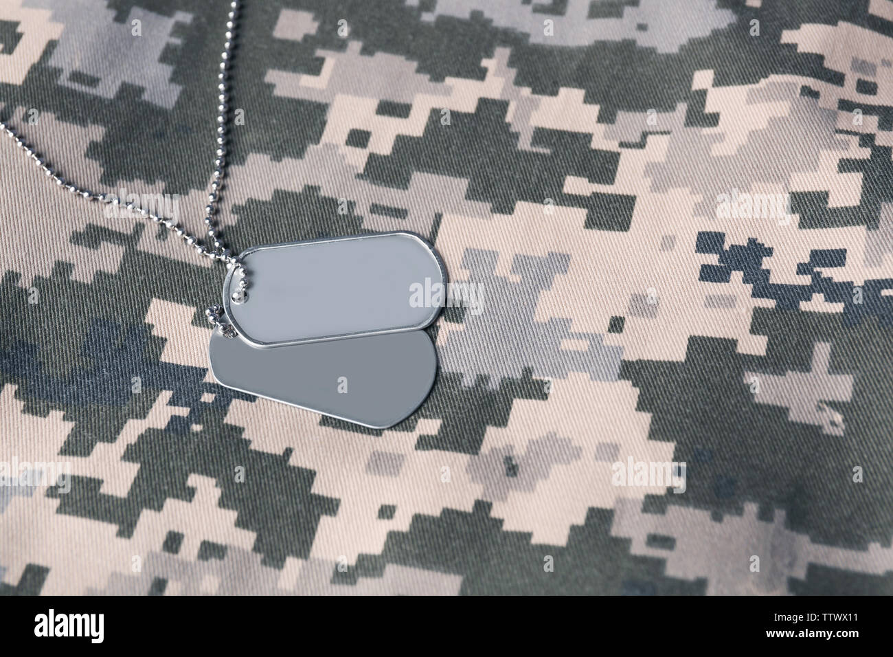 Military ID tag on uniform background Stock Photo - Alamy