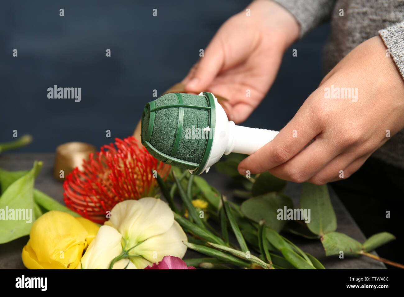 Female hands making beautiful flower composition in floral shop Stock ...