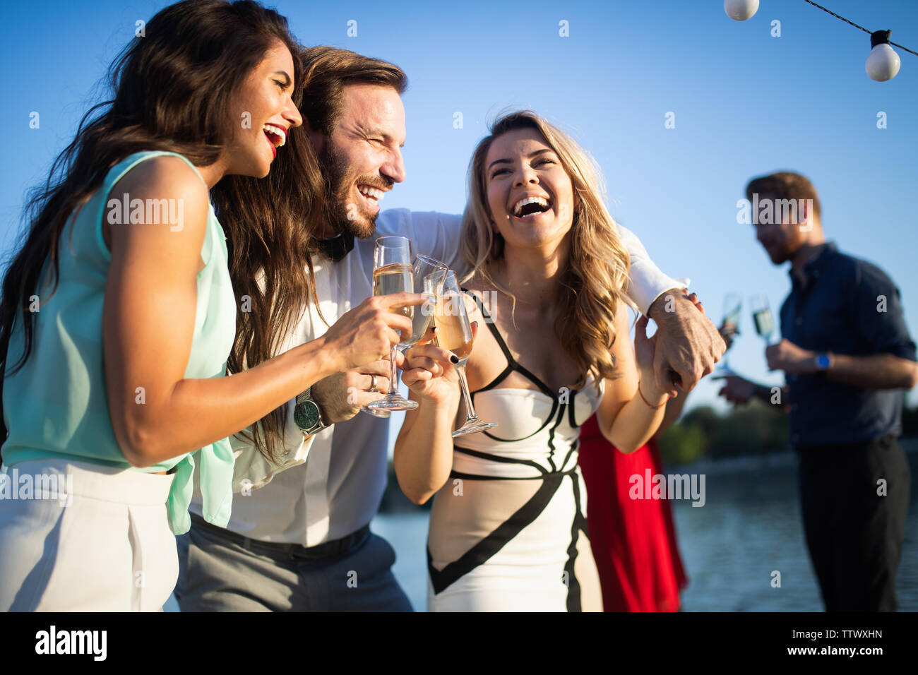 Group of friends at party dancing and smiling together Stock Photo - Alamy
