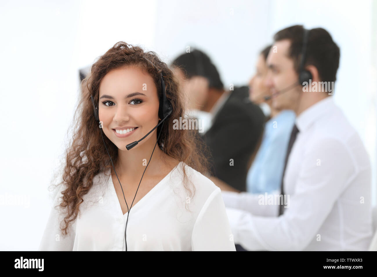 Female call center operator working in office Stock Photo - Alamy
