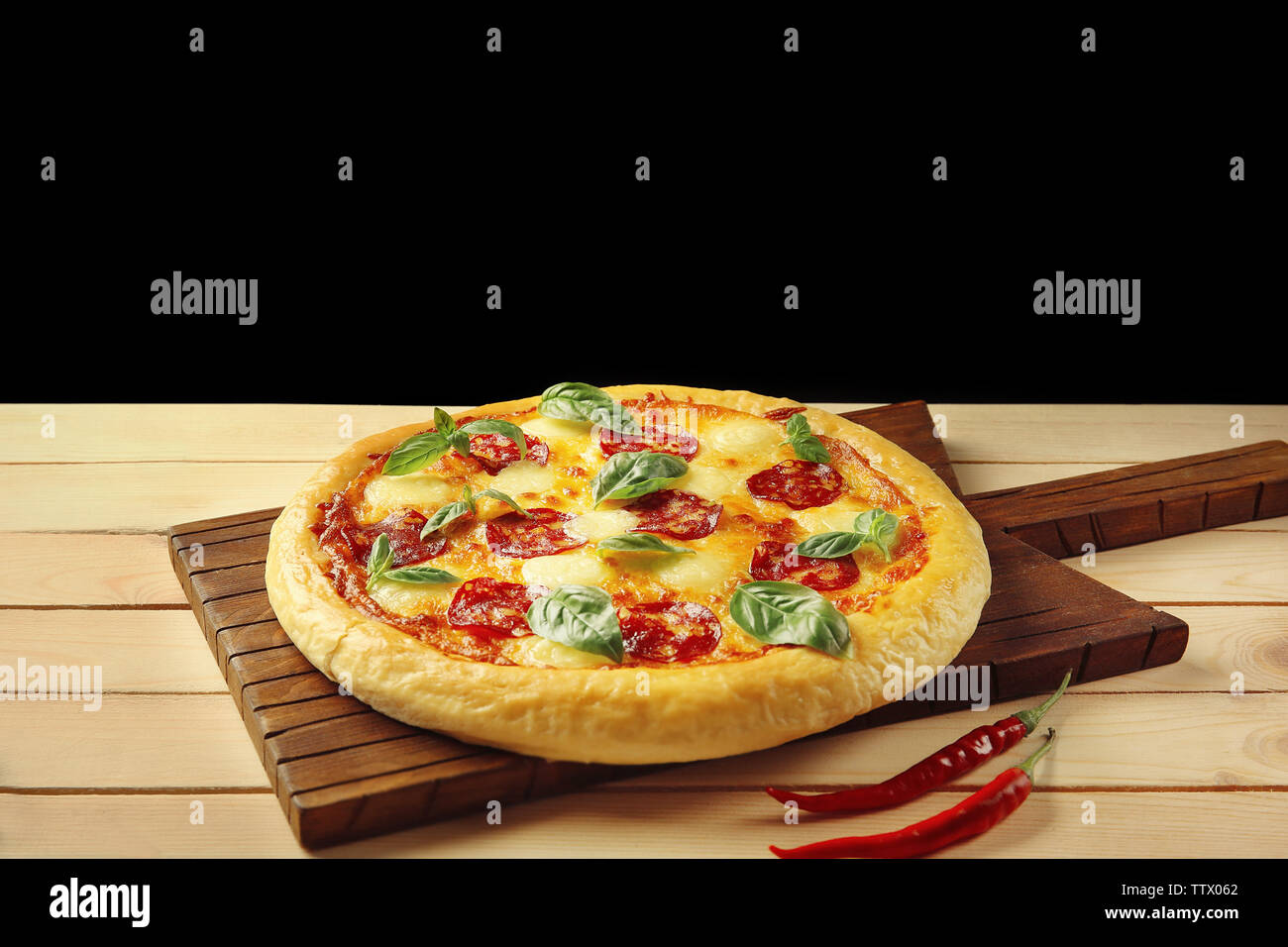 Homemade pepperoni pizza on wooden table Stock Photo - Alamy