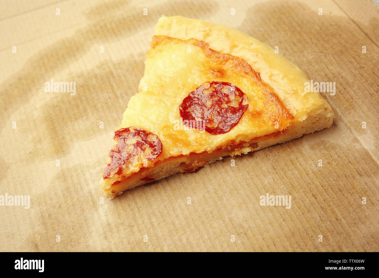 Slice of pepperoni pizza on cardboard Stock Photo - Alamy