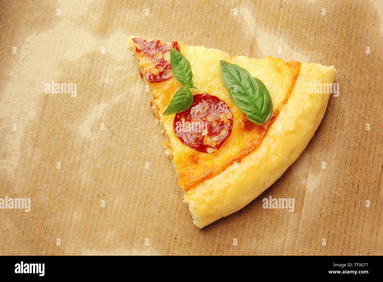 Slice of pepperoni pizza on cardboard Stock Photo - Alamy